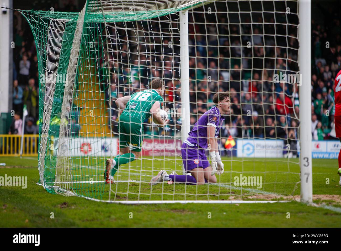 Alex Fisher of Yeovil Town heads ball past Oliver Wright of Worthing ...