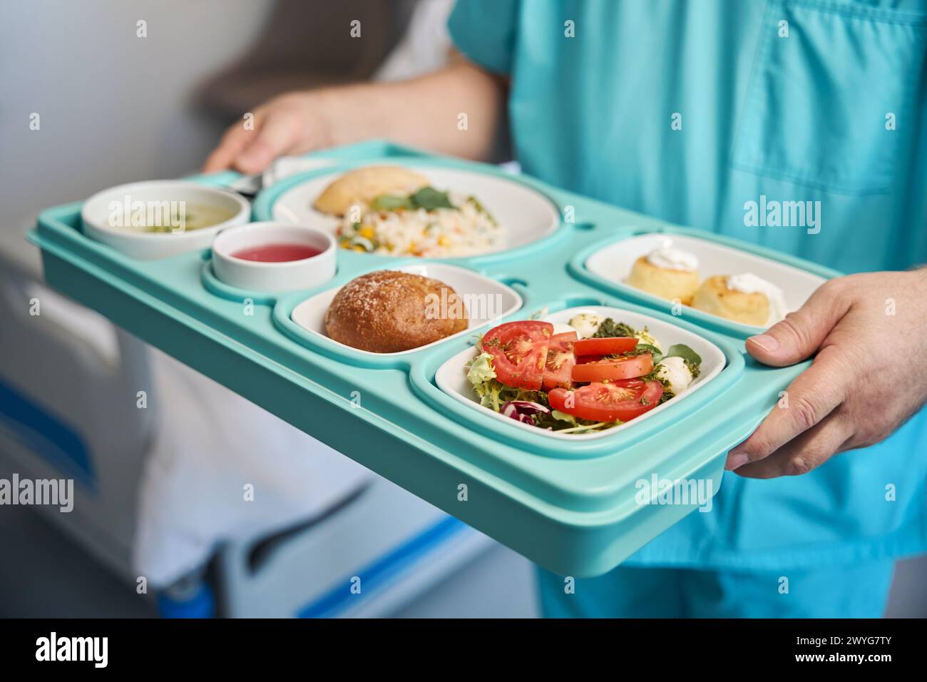 Male nurse is serving dietary meal in medical facility ward Stock Photo ...