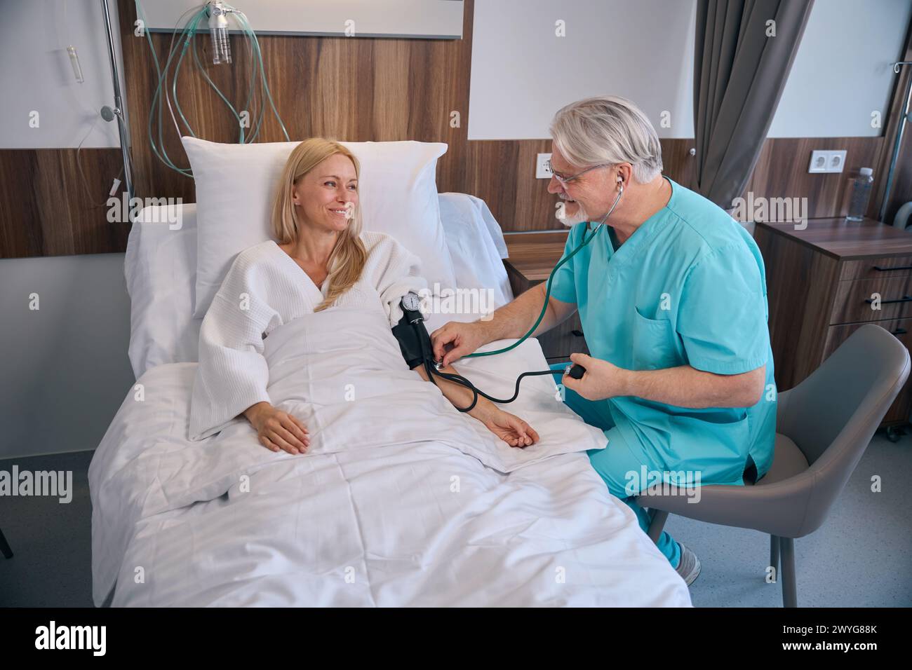 Clinician conducting physical examination of patient using ...