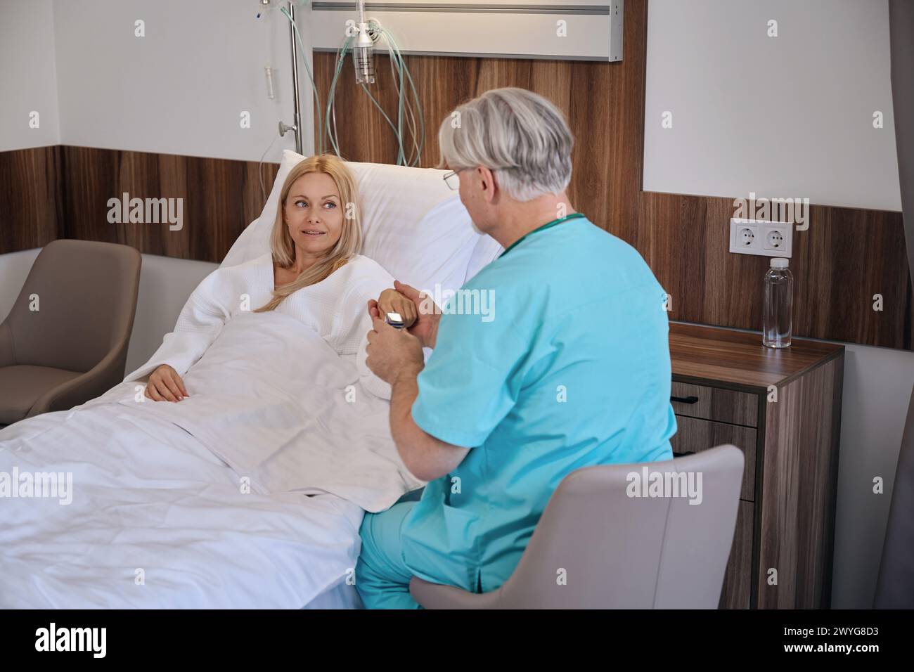 Patient blood oxygen saturation level being measured by attending ...