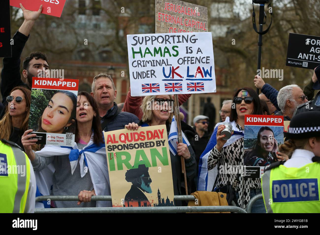 Counter-protesters hold placards during the Al Quds Day protest ...