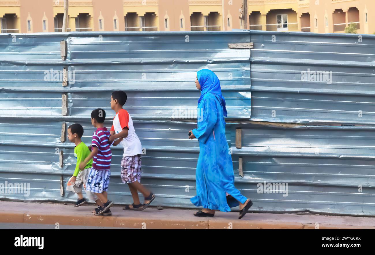 Marrakesh, Morocco - May 9. 2016: Veiled Muslim woman with three ...