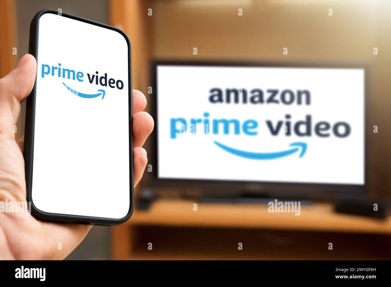 6 April 2024: Man holding smartphone with Prime Video logo in front of ...