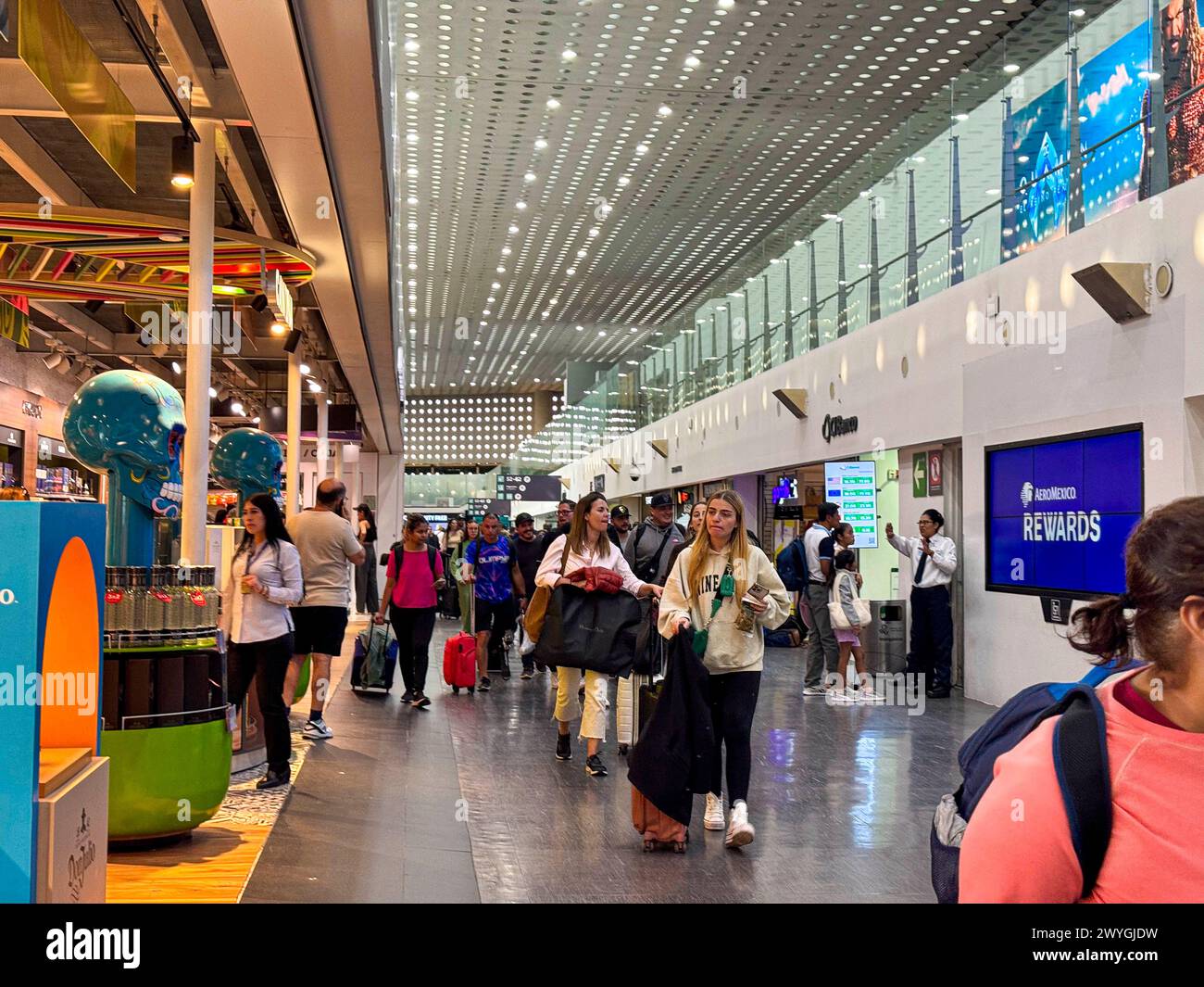 Travelers and tourists in the waiting room of terminal 2 or T2 of the ...