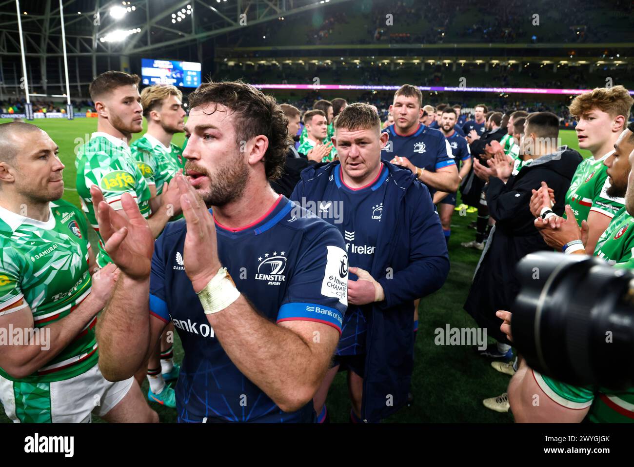 The Leinster players are applauded by the Leicester Tigers players ...