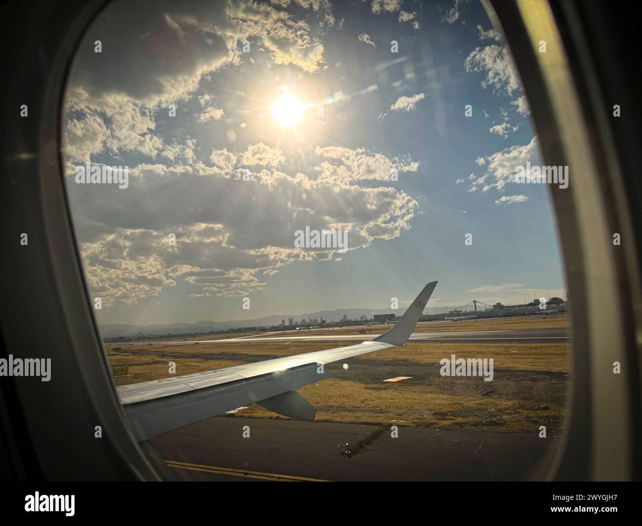 Window and wing of an Aero Mexico airplane arriving at terminal 2 or T2 ...