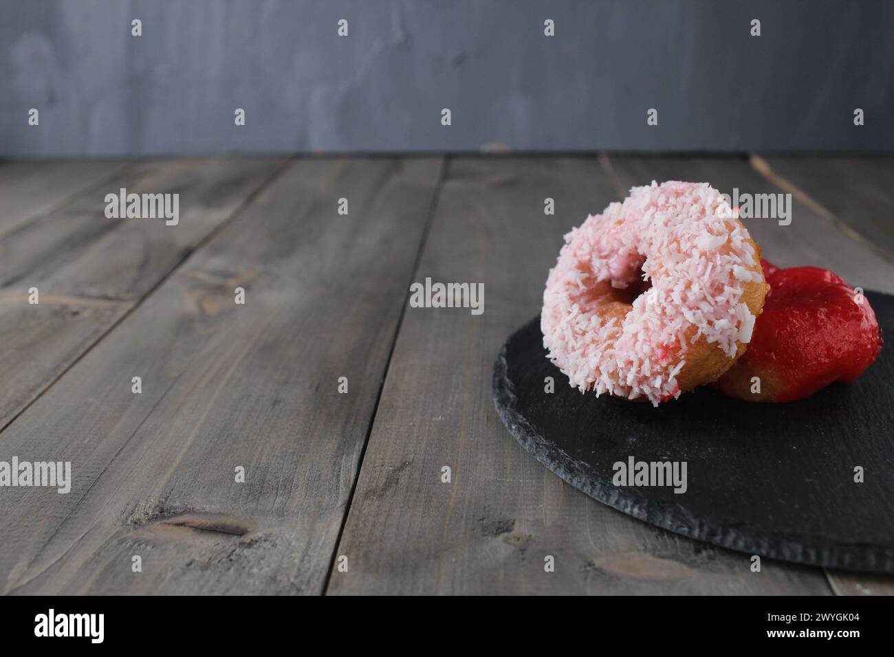 Round donuts donuts with white coconut sprinkles on grey background ...