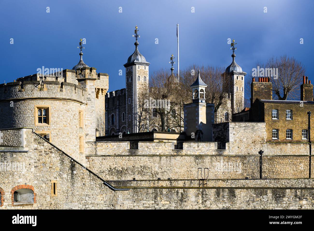 External view of walls and towers of Tower of London under dark sky ...