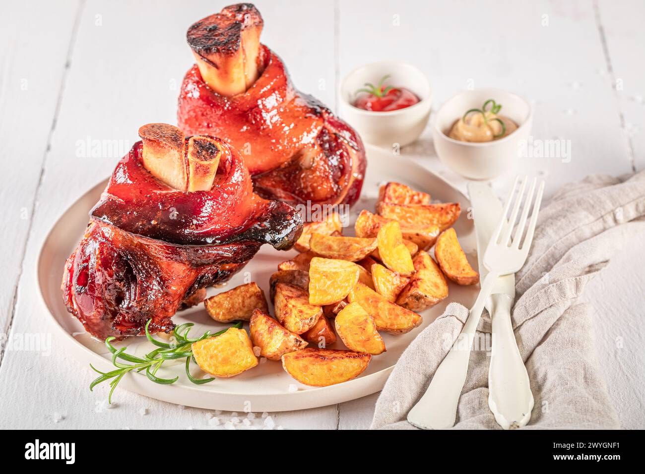 Fresh and cripsy roasted ham hock served with sauerkraut and potatoes ...
