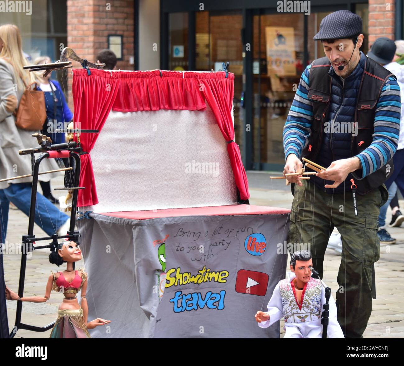 A puppeteer or puppet master manipulates his puppet on Market Street ...