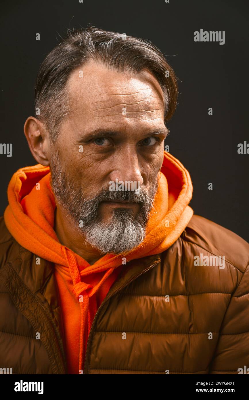 A man with a beard and a hoodie on. He looks angry Stock Photo - Alamy