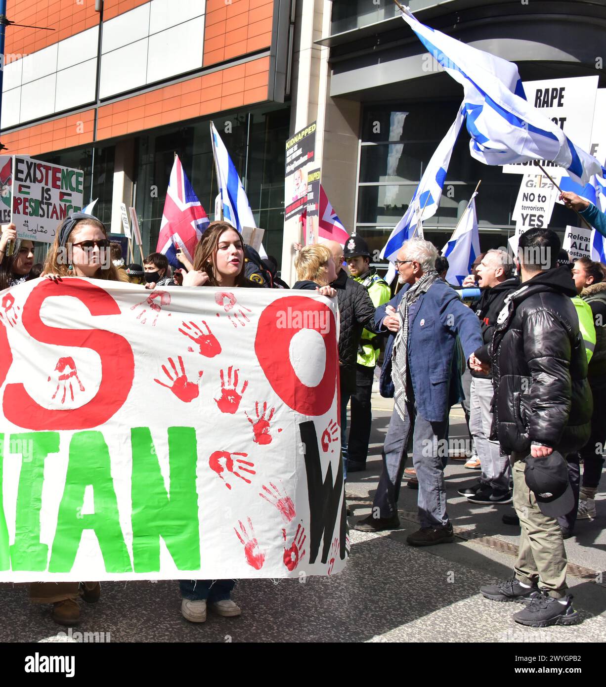 A small pro Israel protest (on right) carrying placards which include a ...