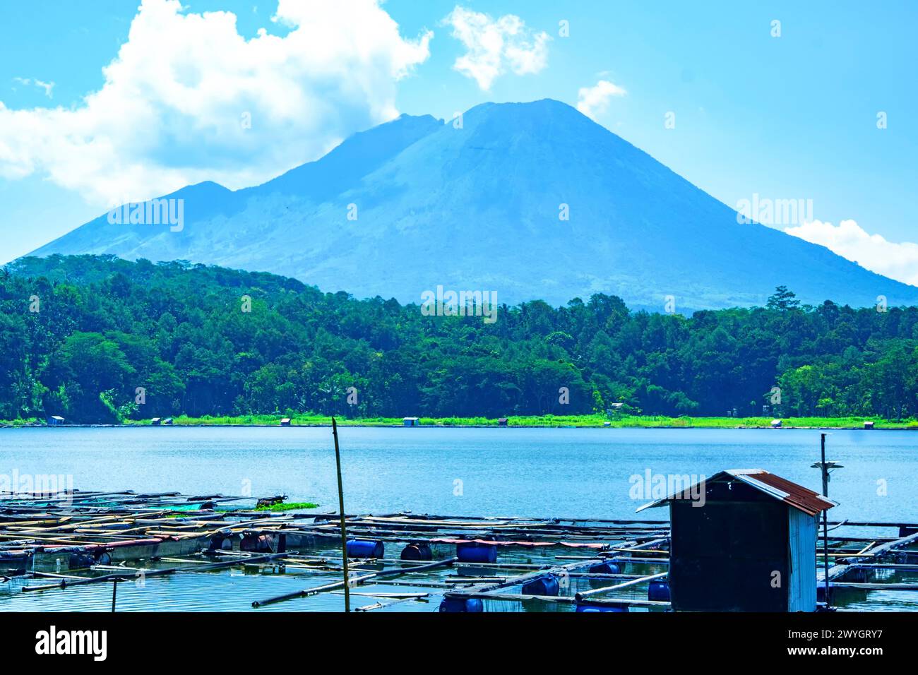 a majestic of Mount Lemongan with a calm lake in front of it. Lush ...