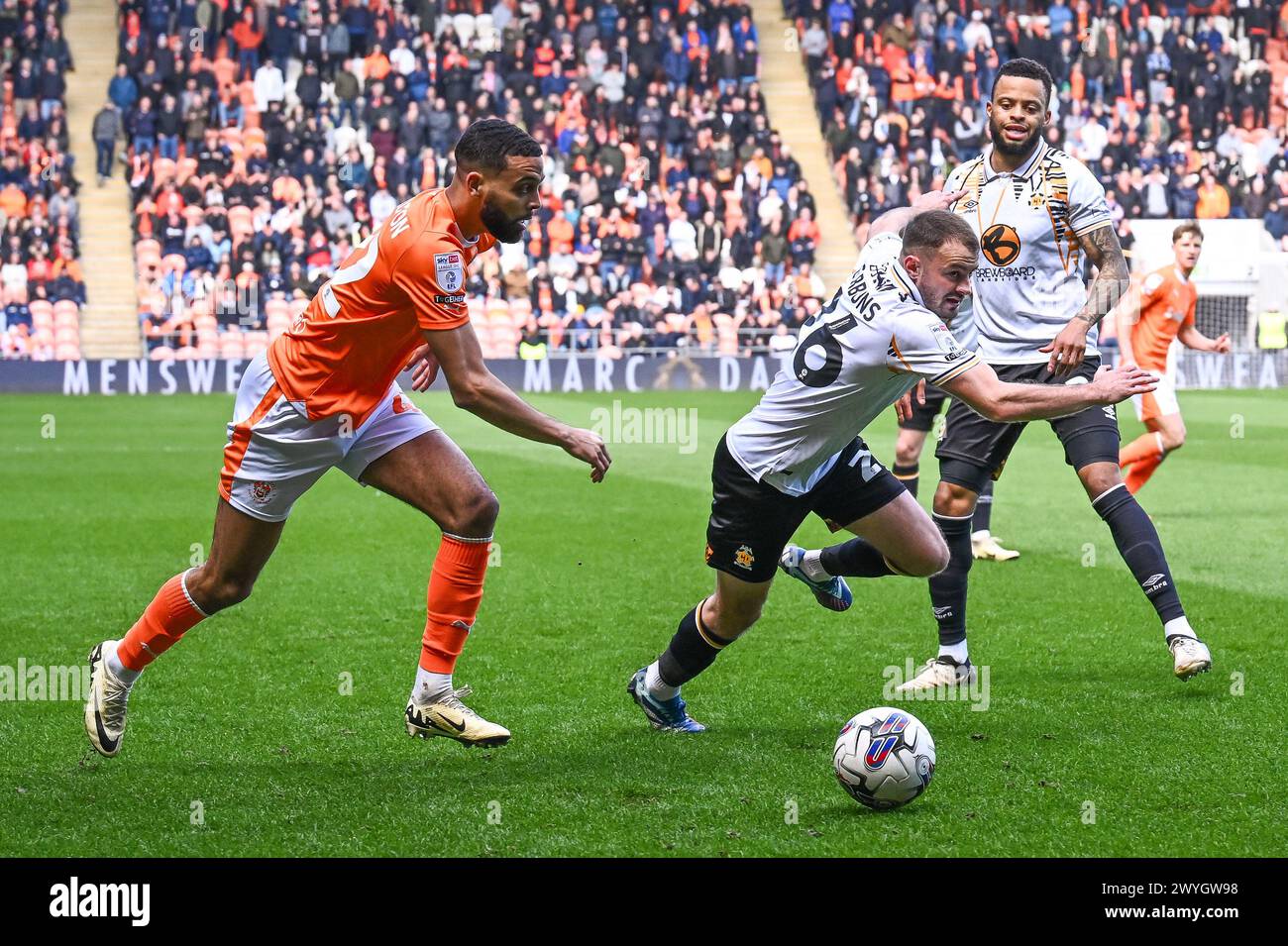 CJ Hamilton of Blackpool takes on James Gibbons of Cambridge United ...