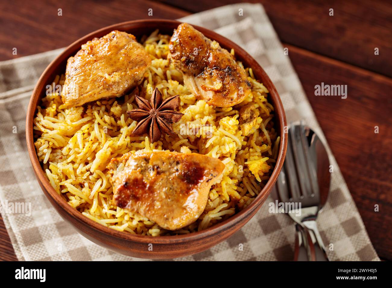 Indian Chicken Biryani in Bowl with Fork and Spoon, Indian Cuisine ...