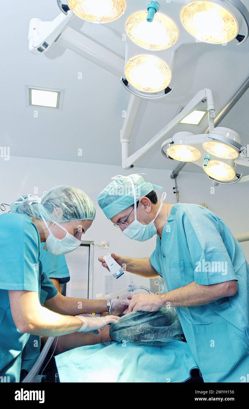 Surgeons during hearing operation at otorhinolaryngology operating room ...