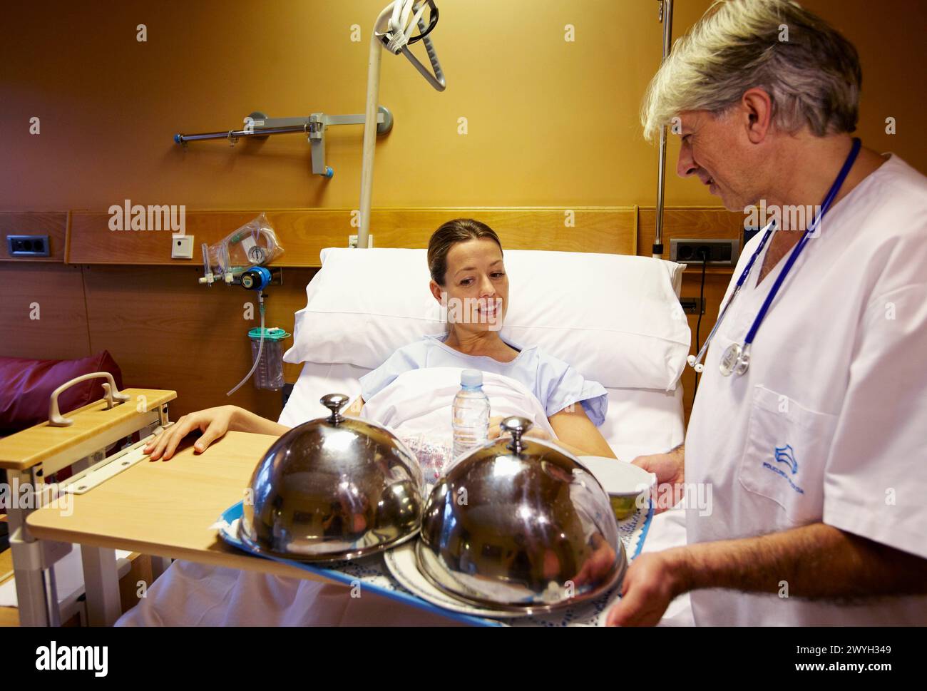 Nurse with food tray and patient in a hospital room. Hospital ...