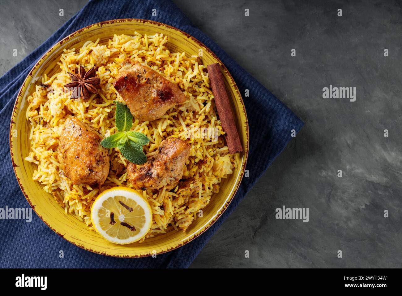 Delicious Indian Dish Chicken Biryani with Spices and Lemon on Yellow ...