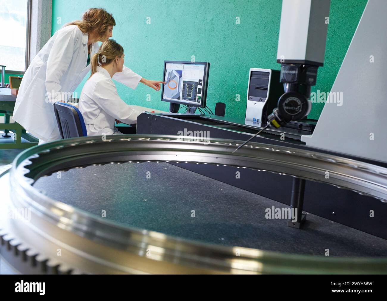 Technicians inspecting aircraft component. Measurement of a piece in ...