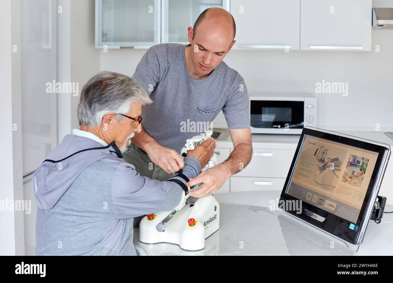 Patient with assistive robot for upper limb rehabilitation, The robot ...