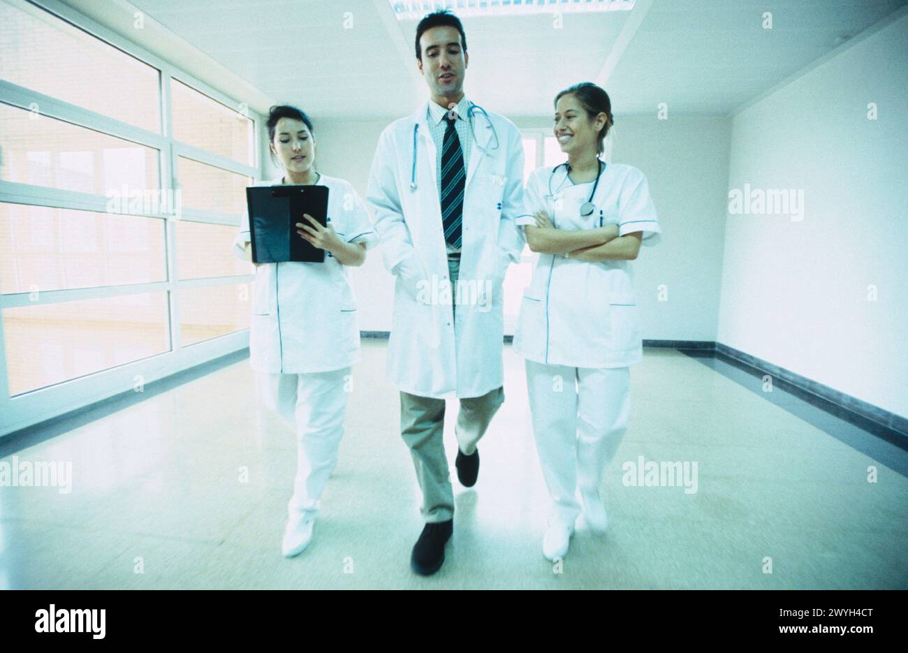 Male doctor female nurses walking hi-res stock photography and images ...