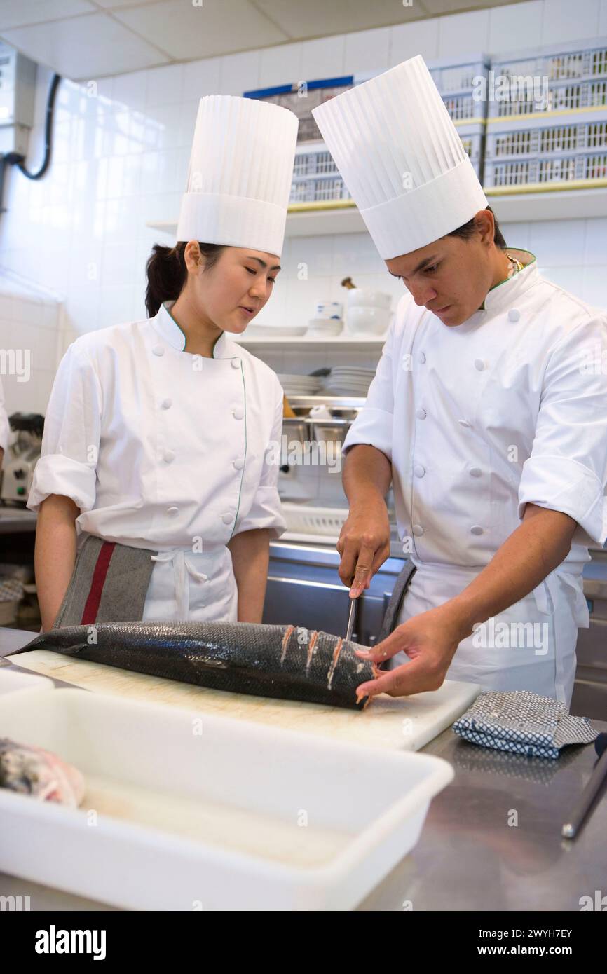 Chefs cutting salmon. Luis Irizar cooking school. Donostia, Gipuzkoa ...