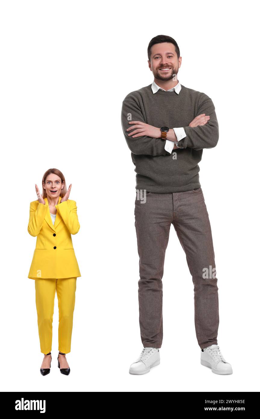 Happy big man and surprised small woman on white background Stock Photo ...