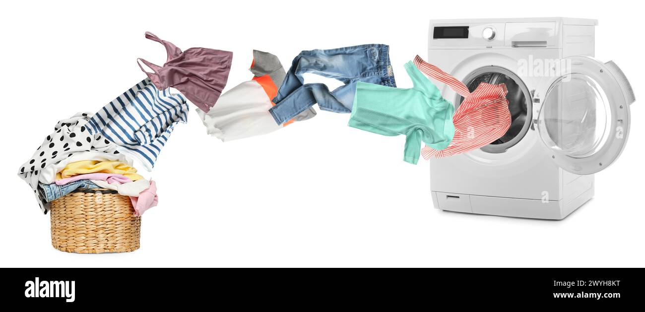 Clothes flying from laundry basket into washing machine on white ...