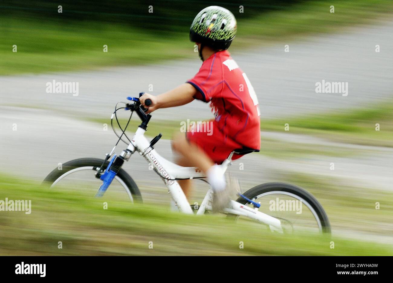 Boy riding a bicycle Stock Photo - Alamy