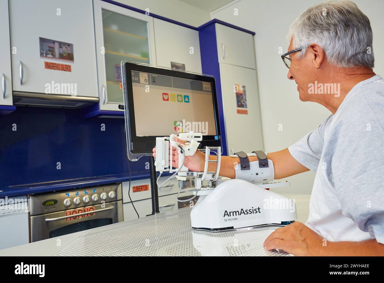 Patient with assistive robot for upper limb rehabilitation, The robot ...