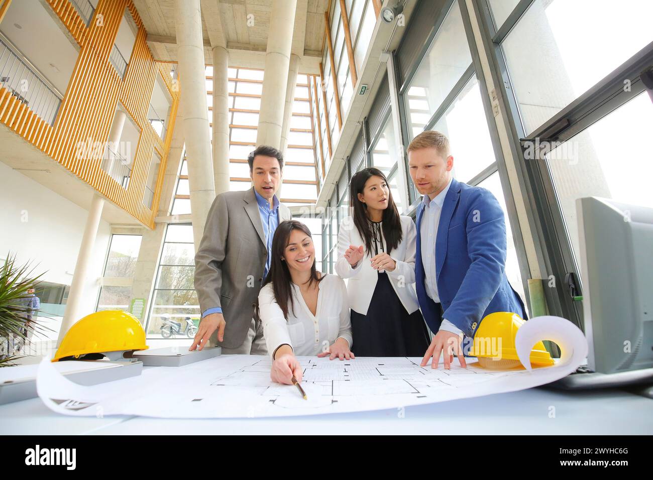 Architects looking at blueprints Stock Photo - Alamy
