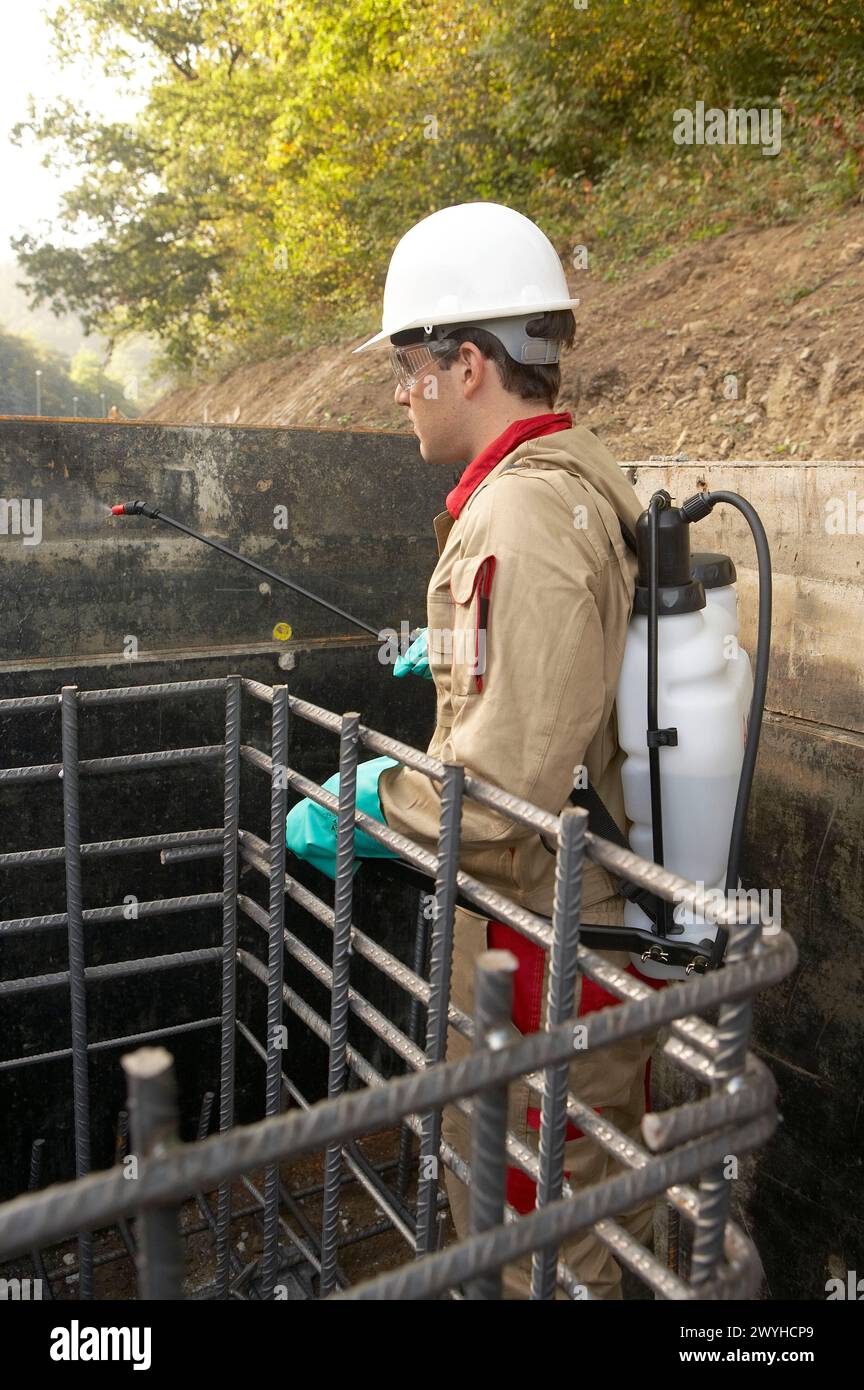 Applying form release agents with sprayer, concrete formworks Stock ...