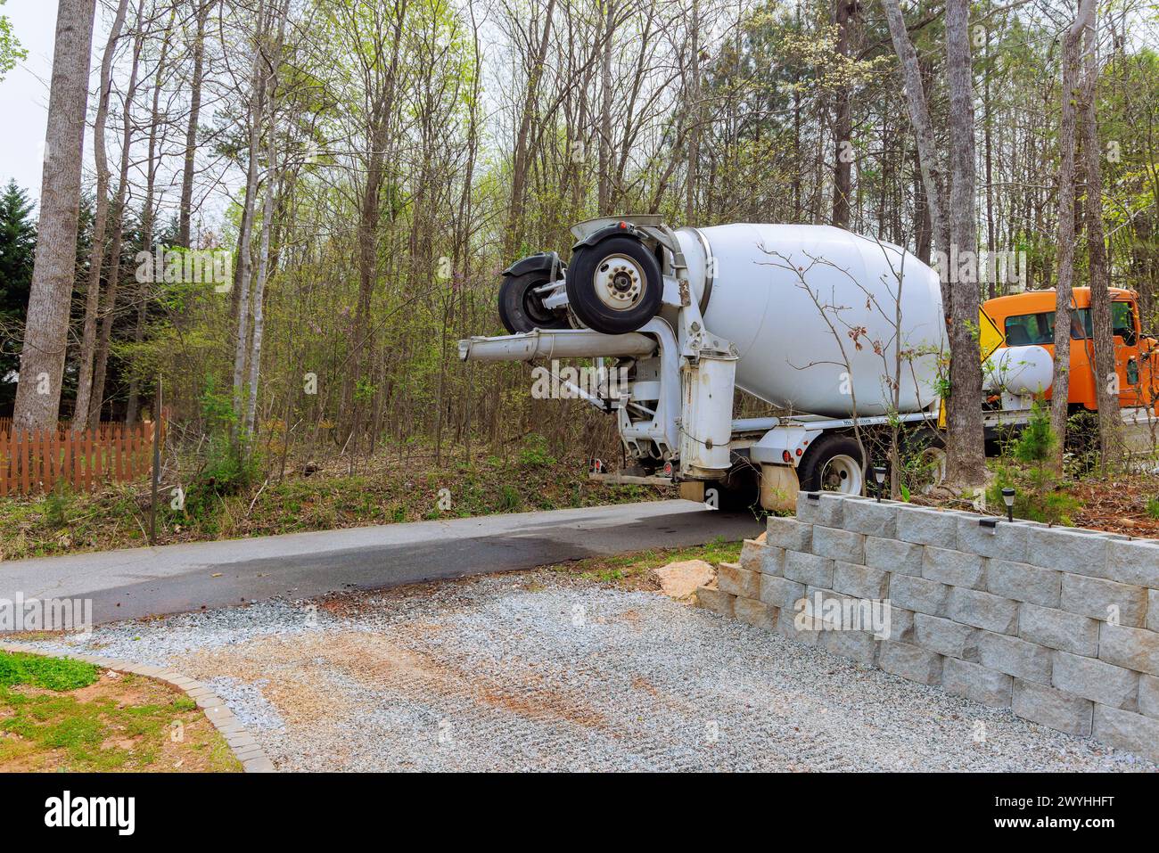 Pouring liquid cement concrete from concrete mixer truck at ...