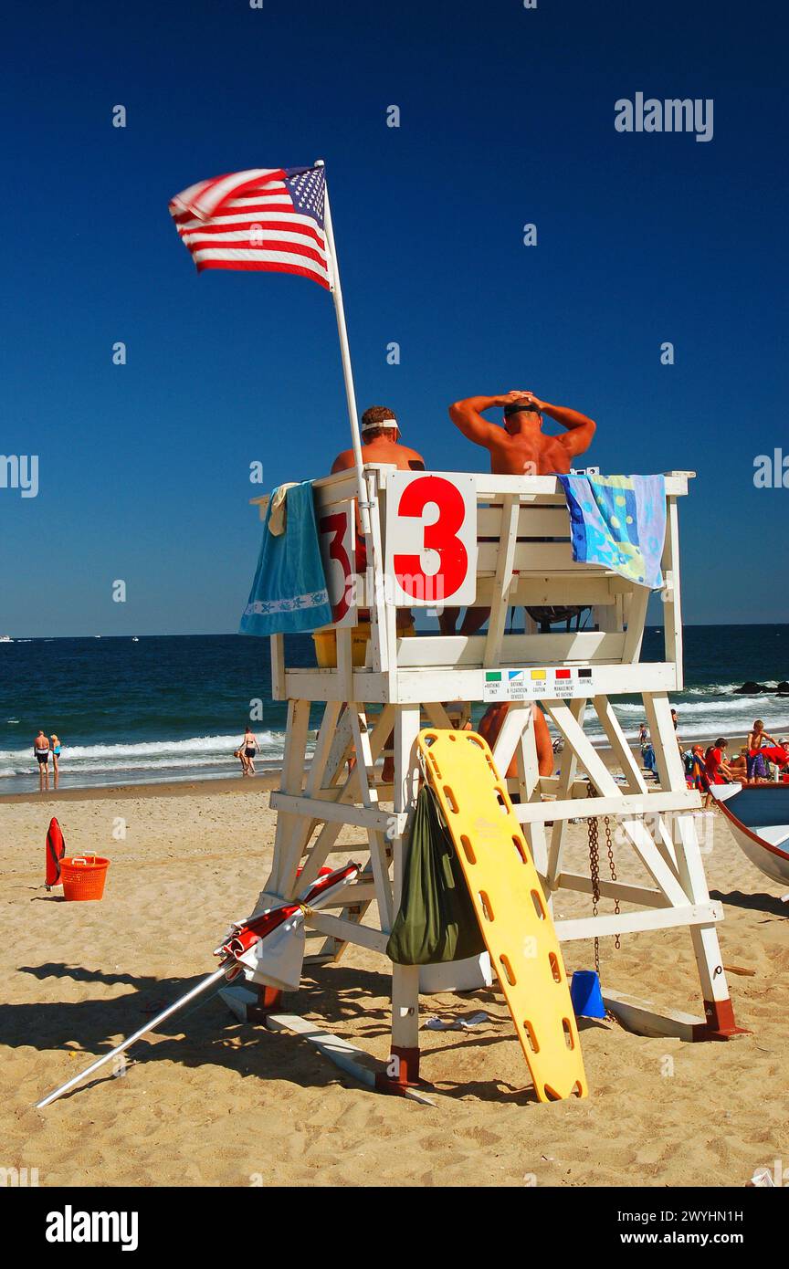 Two Lifeguards Sit In The Tower And Watch Over The Tourists And The