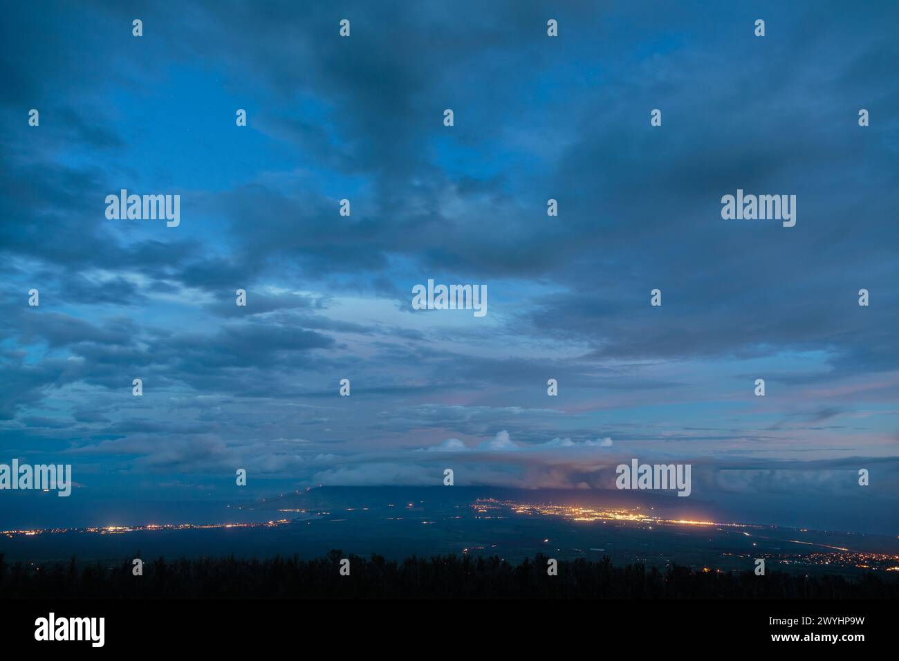 Pre-dawn light and clouds move through Maui from the side of Haleakala ...