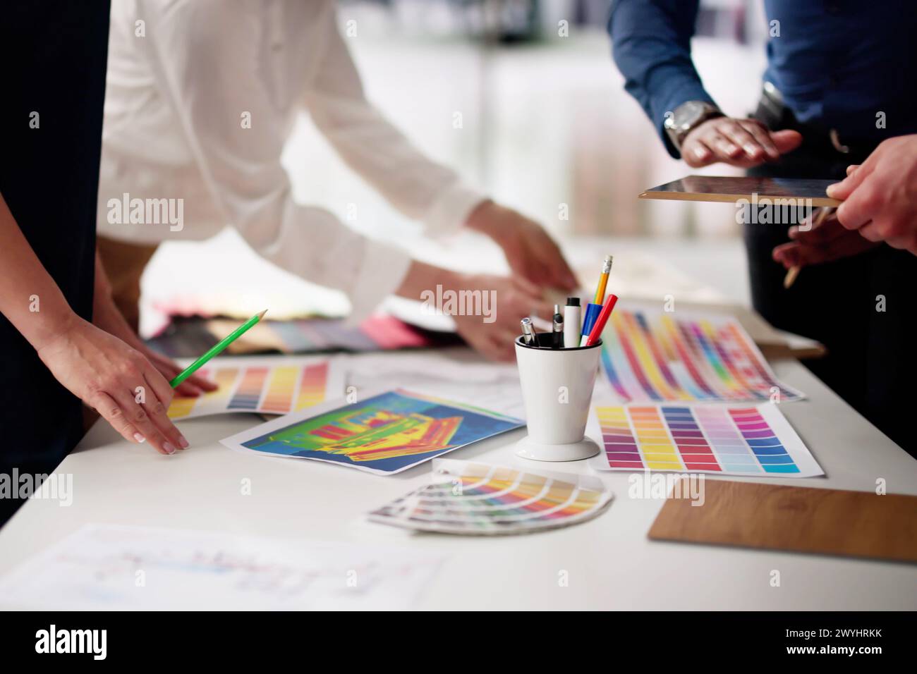 Designer Group At Desk Discussing Custom House Remodel Stock Photo - Alamy