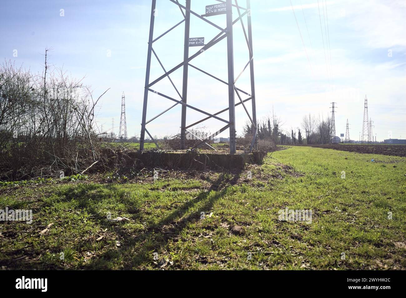 Grass path next to a ploughed field and a trench bordered by cutted ...