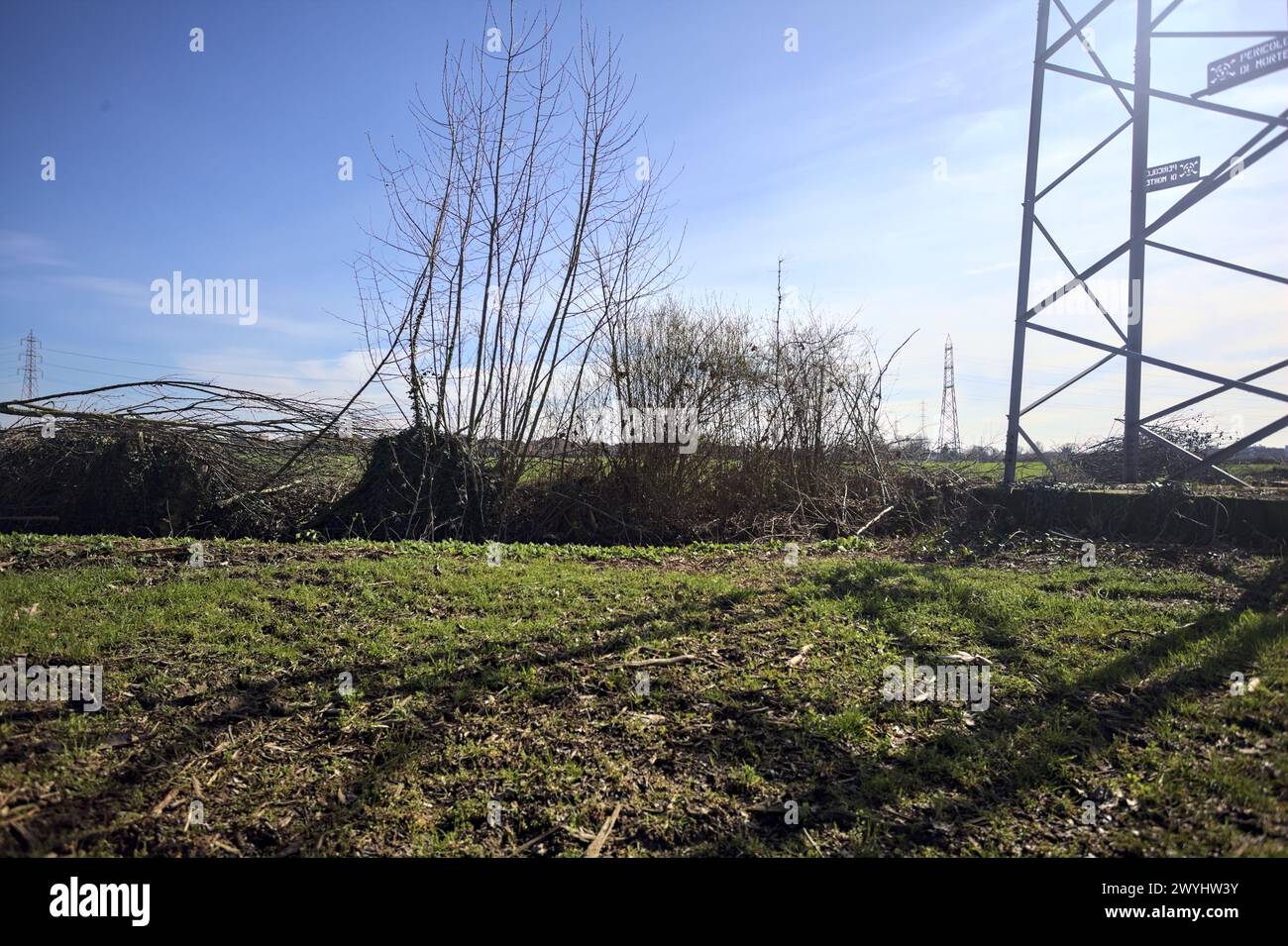 Grass path next to a ploughed field and a trench bordered by cutted ...