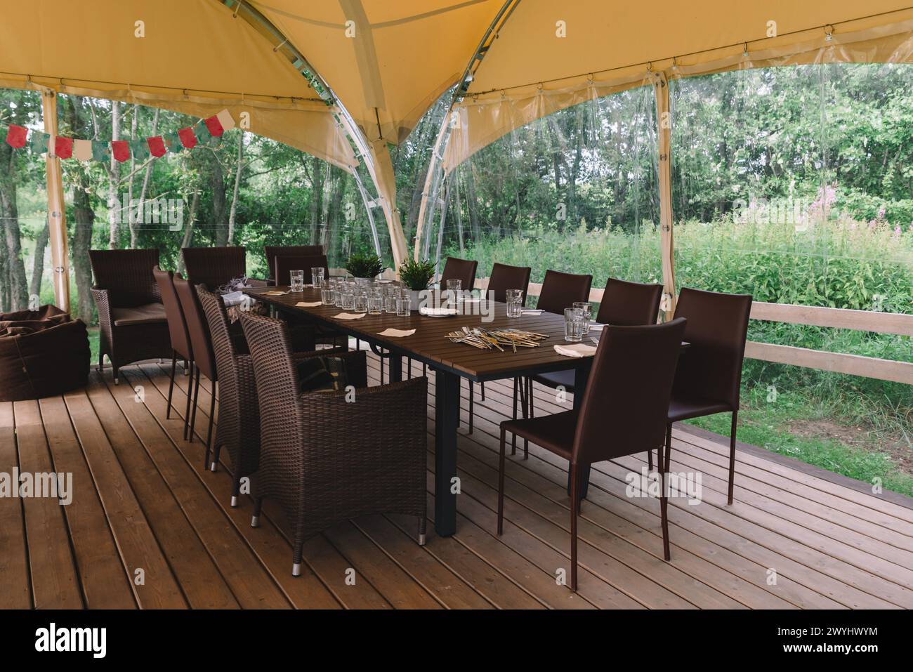 An inviting outdoor dining arrangement under a yellow canopy ...