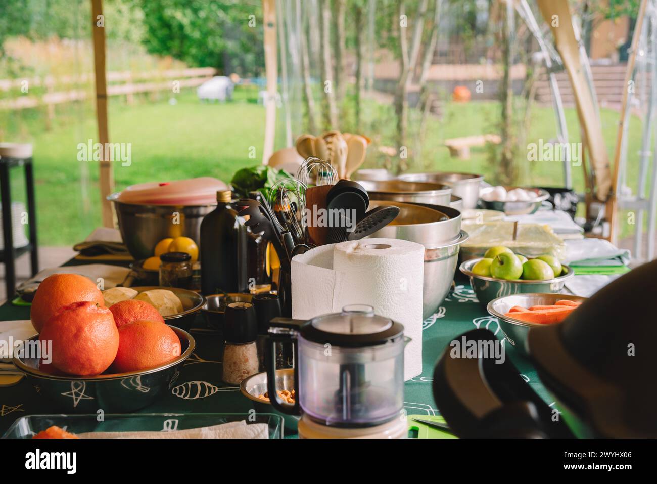 An outdoor kitchen filled with cooking utensils and fresh produce on a ...
