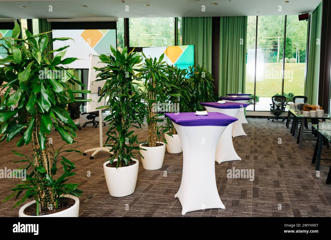 A contemporary corporate event space featuring high cocktail tables ...