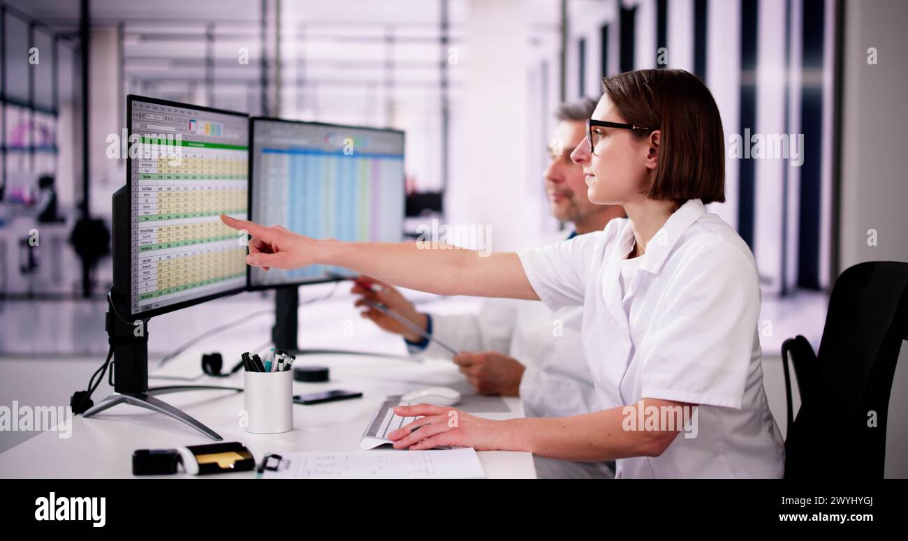 Hospital Doctor Using Spreadsheet For Billing Codes On Desktop Stock ...