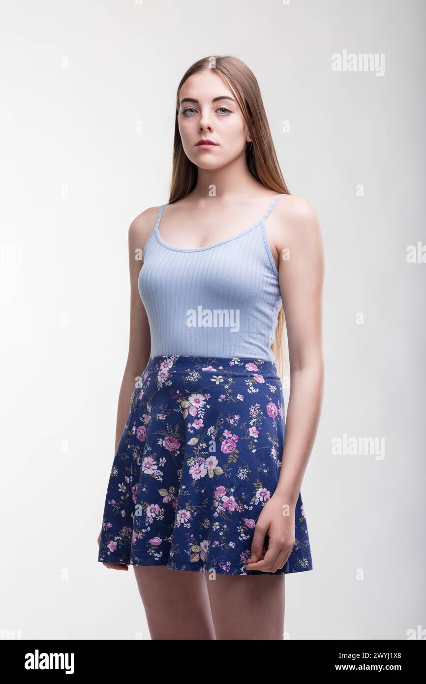 Young woman poses confidently, light gaze conveying subtle curiosity ...