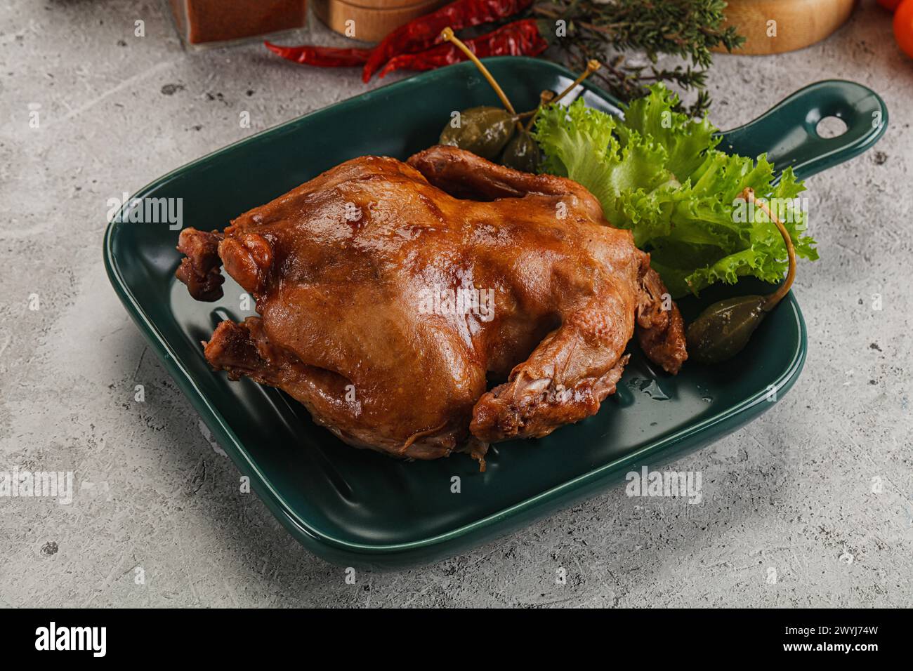 Baked whole small chicken with spices Stock Photo - Alamy