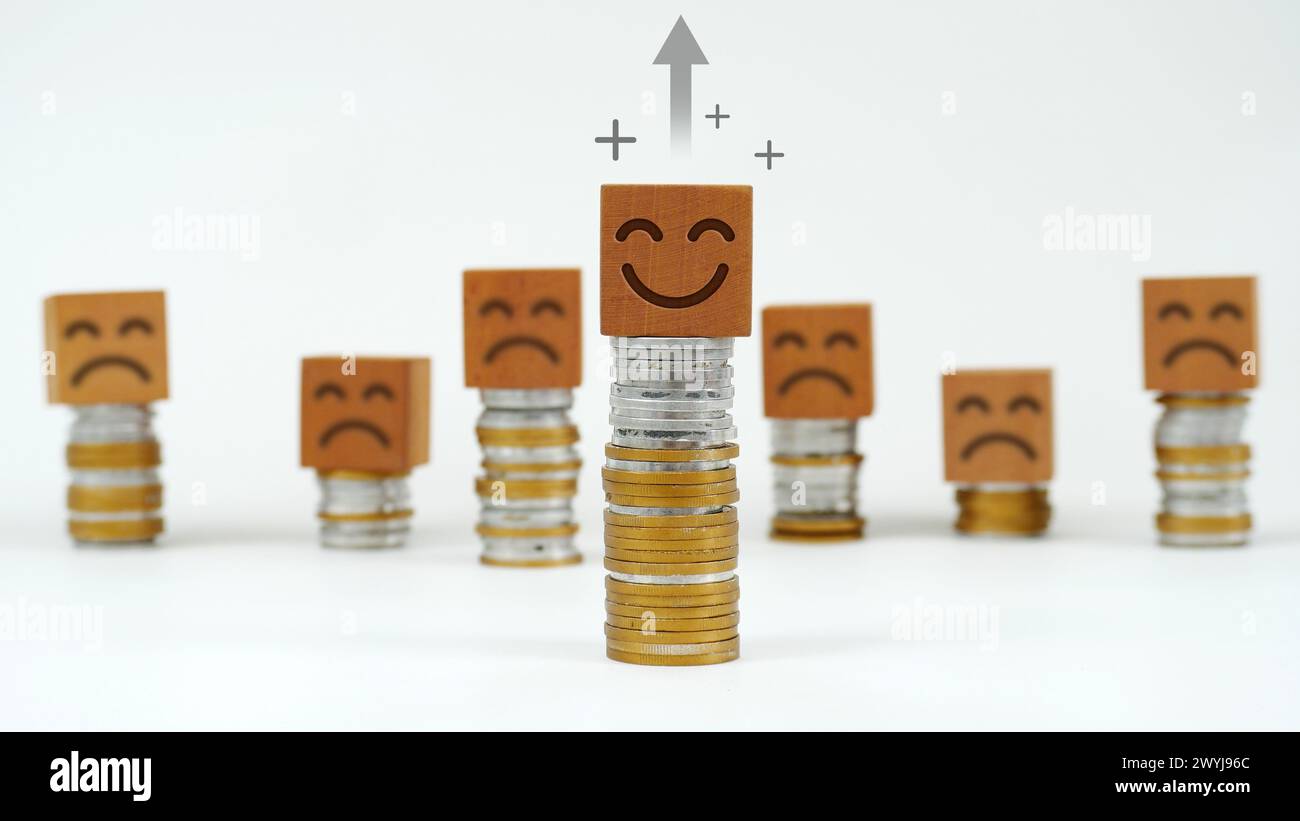 closeup of a smiley face on wood above a pile of coins with a blurred ...