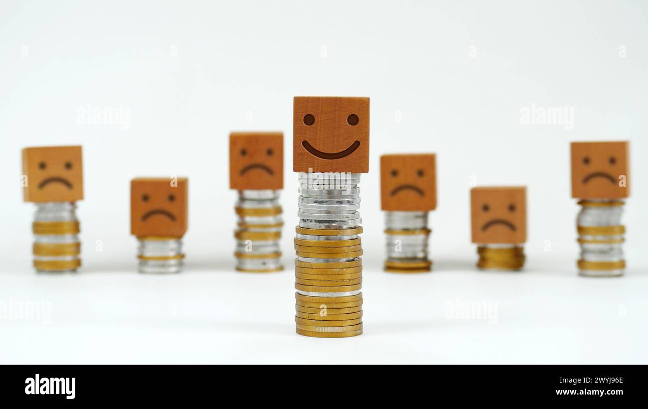 closeup of a smiley face on wood above a pile of coins with a blurred ...
