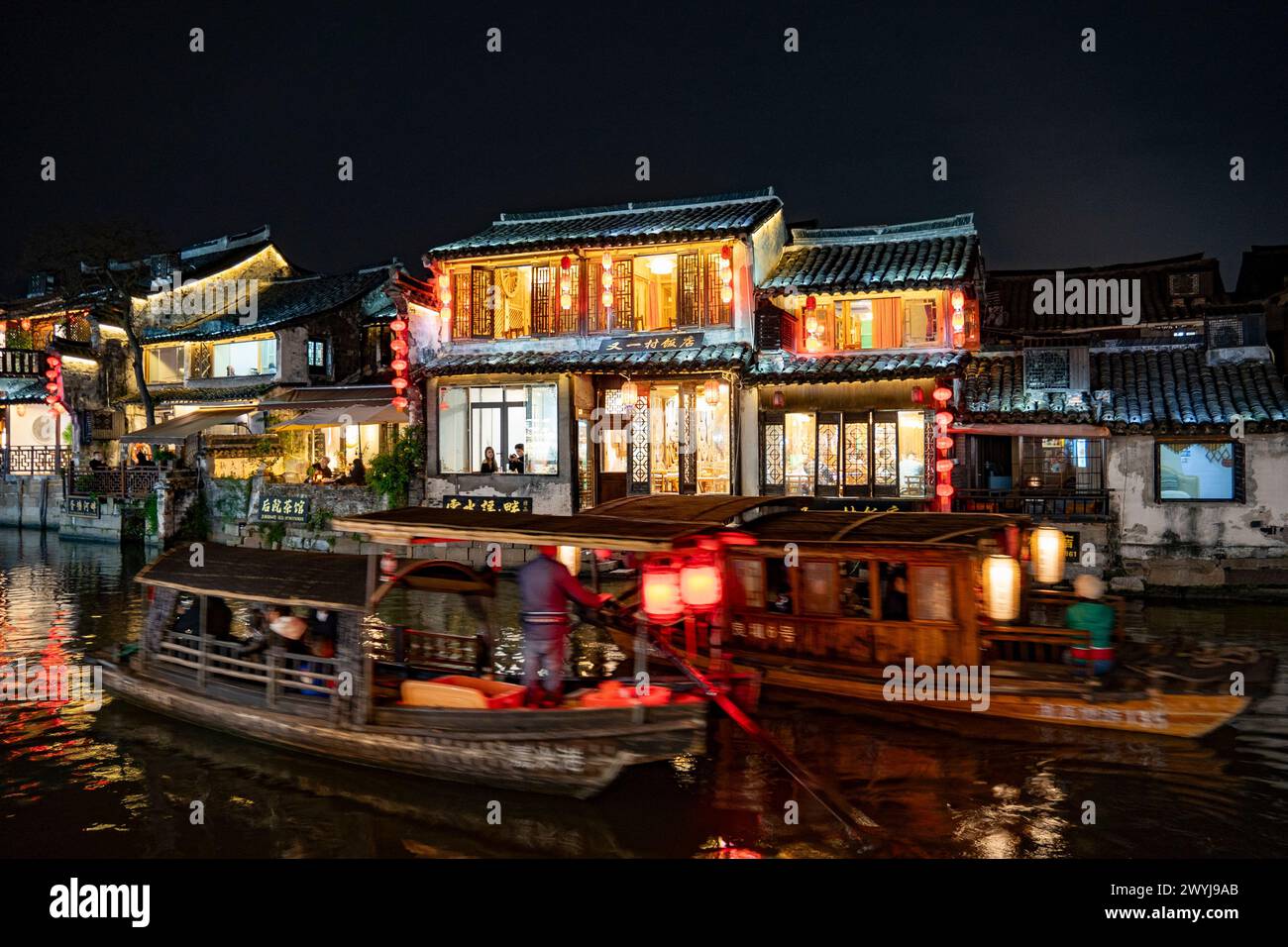 JIAXING, CHINA - APRIL 6, 2024 - Tourists wearing Hanfu enjoy the night ...