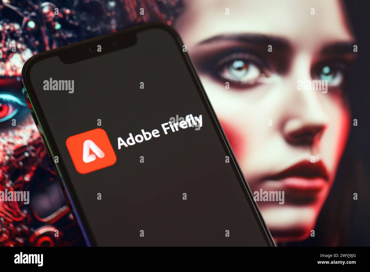 KYIV, UKRAINE - MARCH 17, 2024 Adobe Firefly logo on iPhone display screen with background of ...