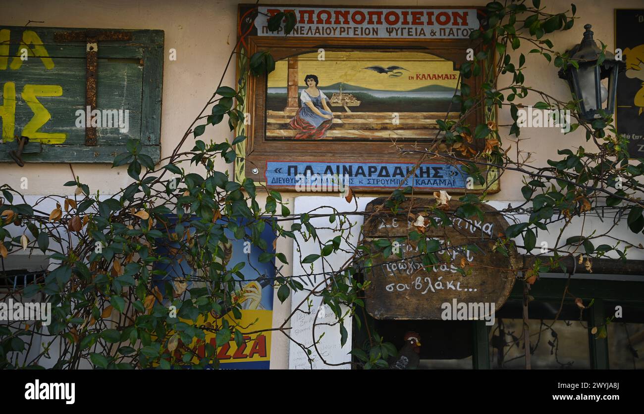 Traditional Greek taverna facade with retro signs in downtown Kalamata ...