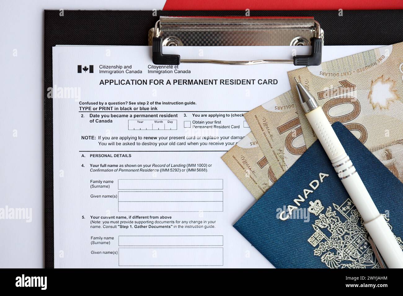 Application for permanent resident card on table with pen and canadian ...
